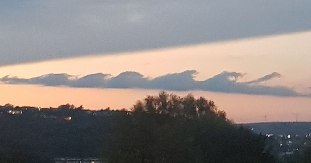 The photos capturing a rare wave-shaped cloud above…