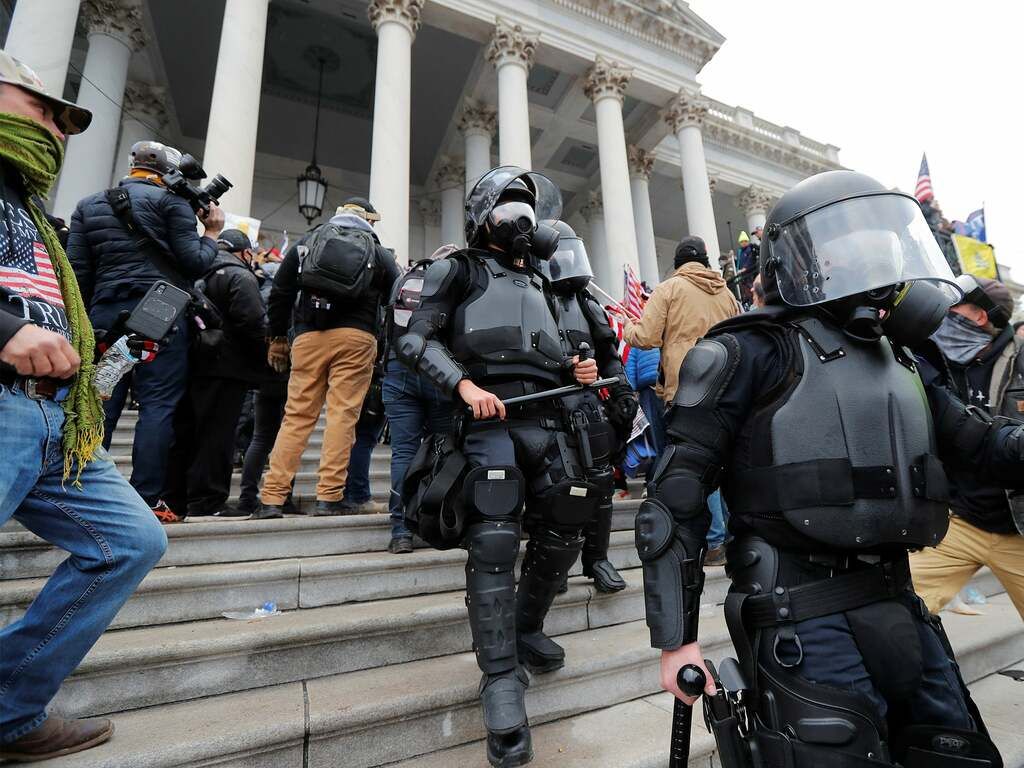 Capitol riots: Shocking video shows mob dragging…