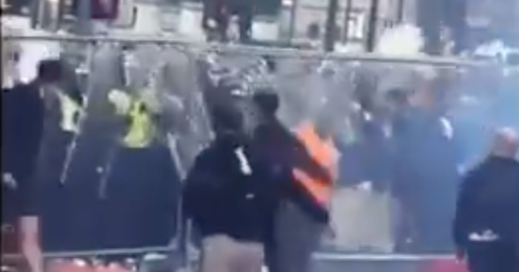 Shock moment riot cops are pelted with flares and…