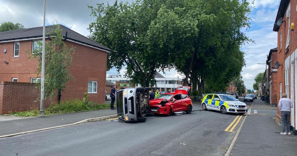 Shocking pictures show van flipped onto its side in…