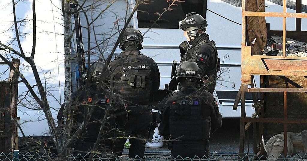 Watch armed police and specialist officers surround…