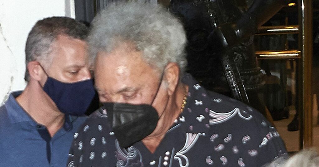 Singer Tom Jones pictured with walking stick as he…