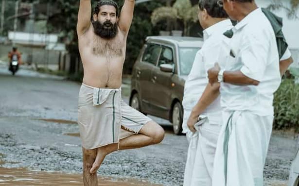 Taking bath in pothole to draw officials’ attention