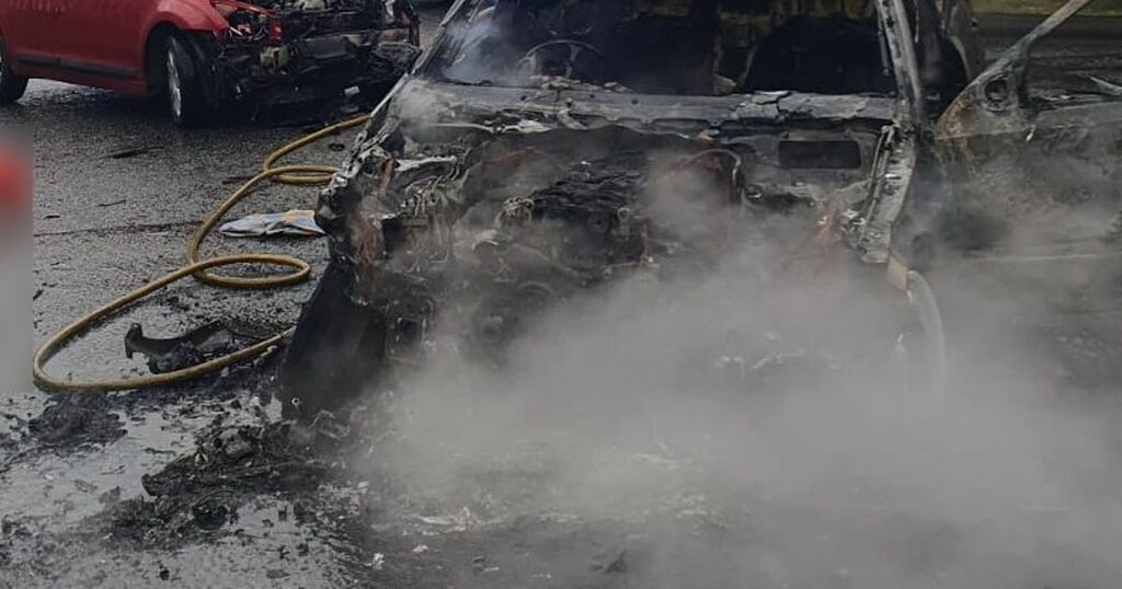 Car bursts into flames after crash as firefighters…