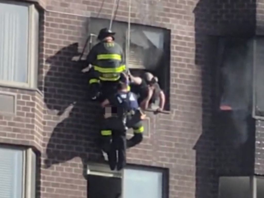 Woman filmed dangling from 20th-floor window in…
