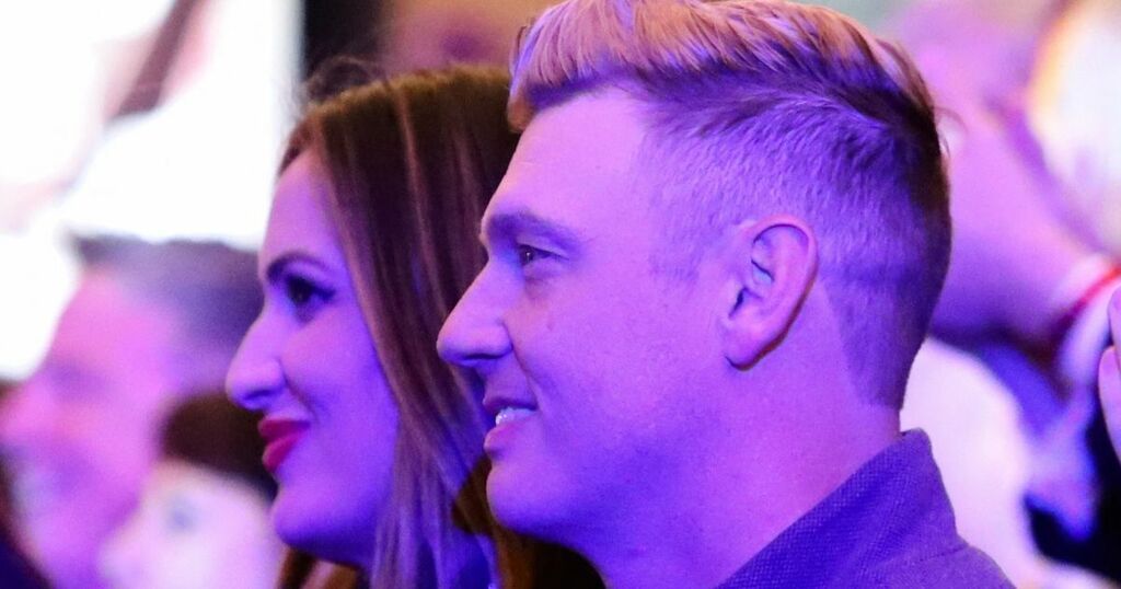 Nick and Angel Carter put on brave faces as they unite…