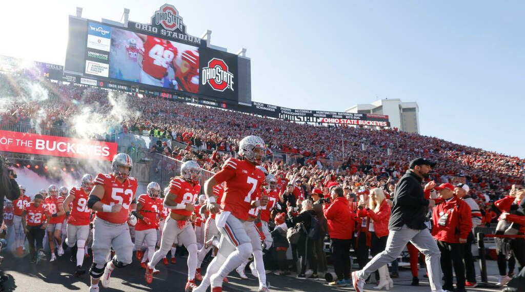 Sports Illustrated - Fan Wearing OSU and Michigan Gear…