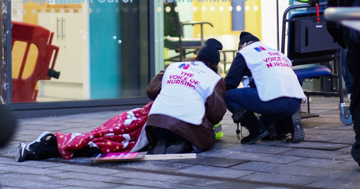 Striking nurses rush from picket line and give first…