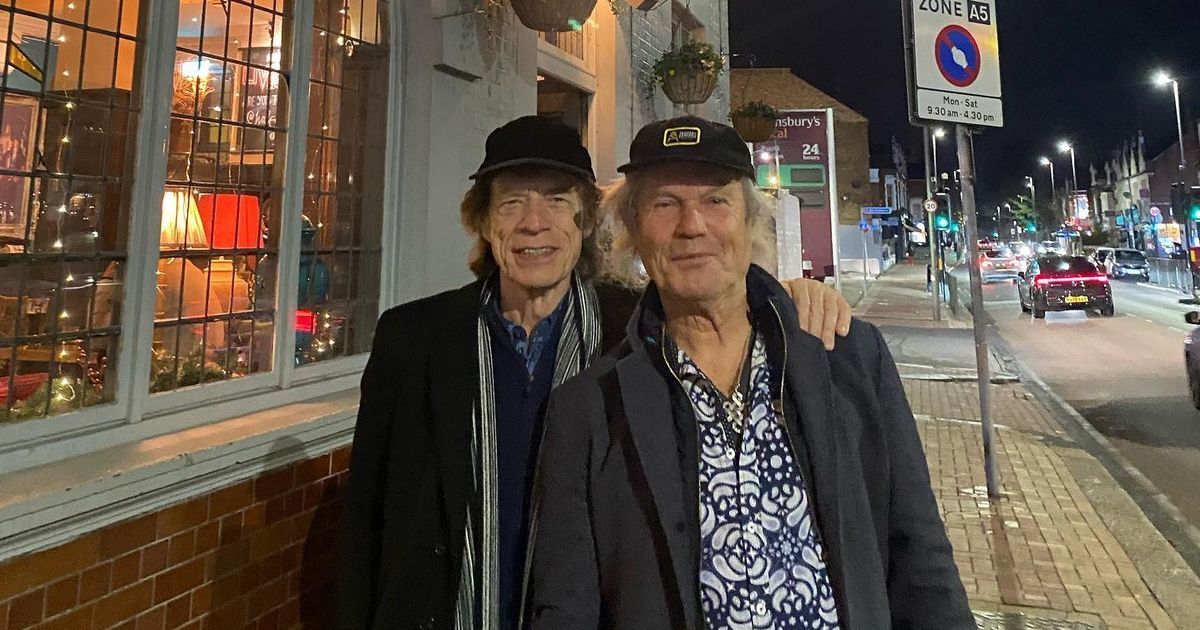 Mick Jagger and brother smile as they pose outside pub…