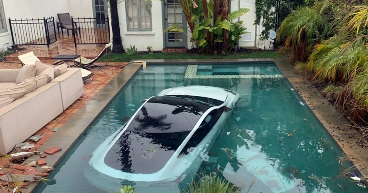 Tesla crashes through wall and into swimming pool as…