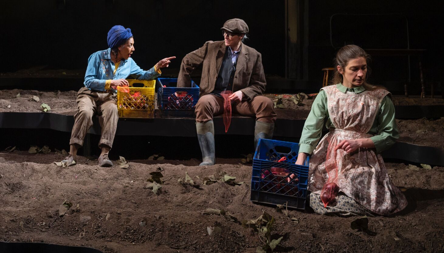 Working in an onstage dirt patch, ‘Fen’ cast faces…