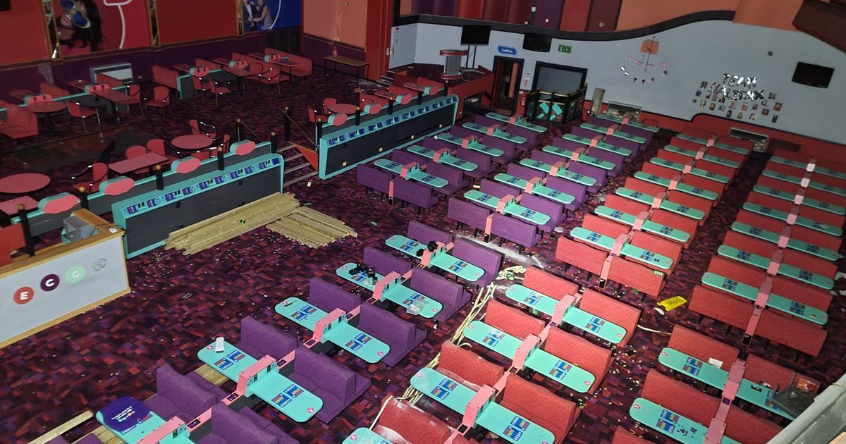 Inside abandoned Mecca bingo hall with rows of tables…