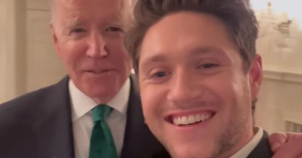 Niall Horan poses with President Biden as fans…