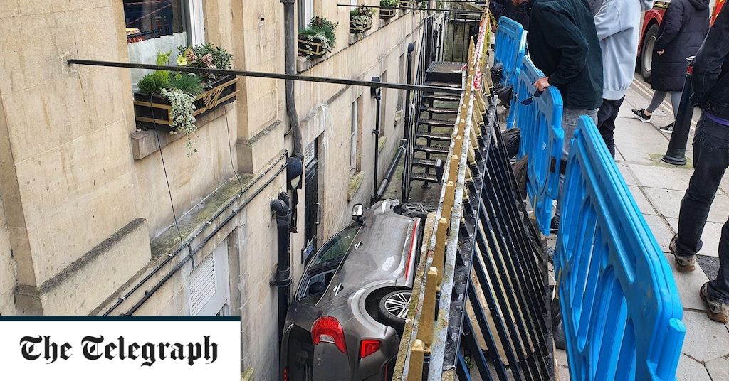 Car wedged in alley outside historic Bath hotel