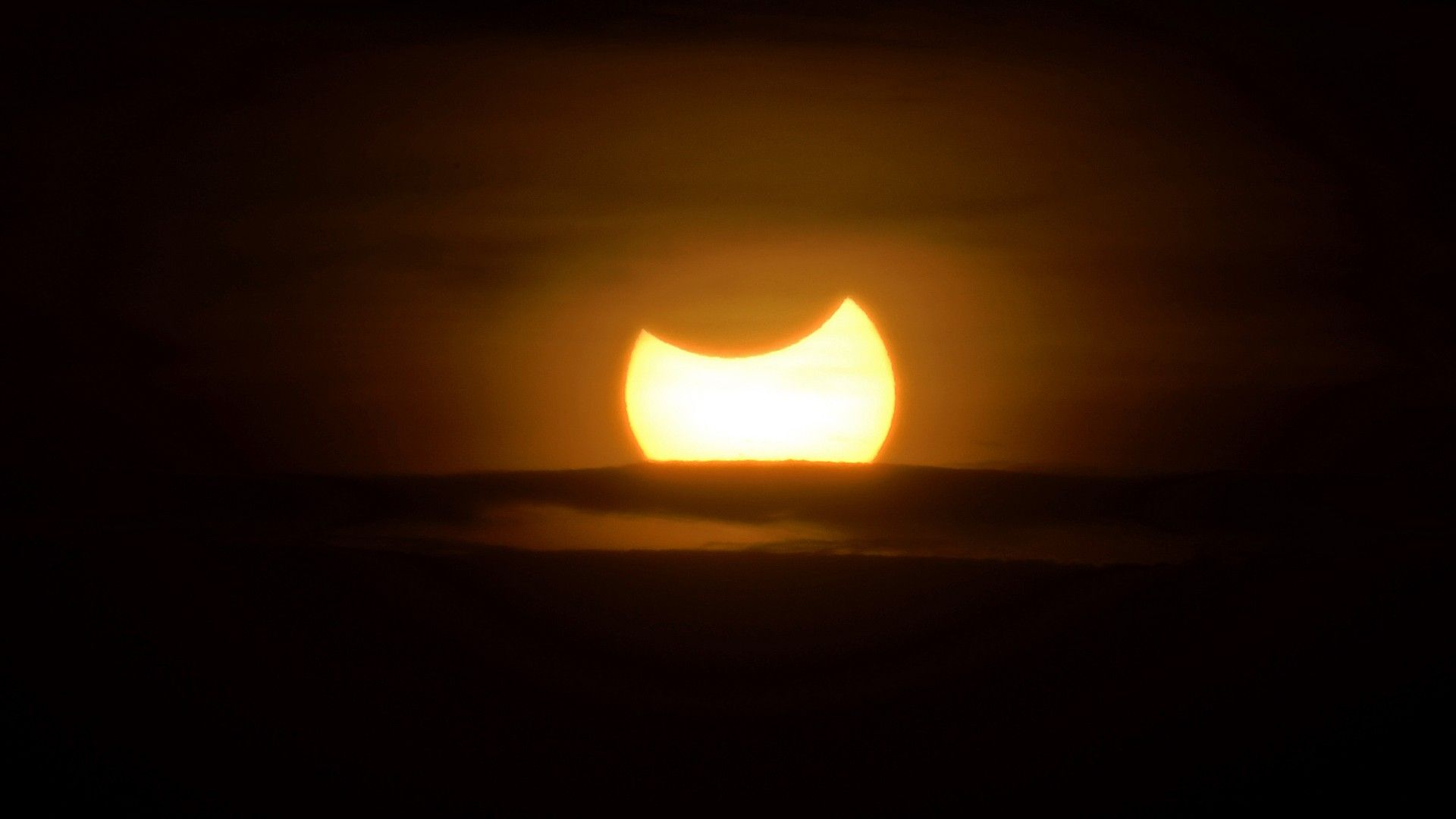 The moon blocks the sun in a rare hybrid solar eclipse…