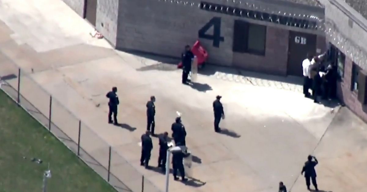 Prison riot as cons throw things and block windows…