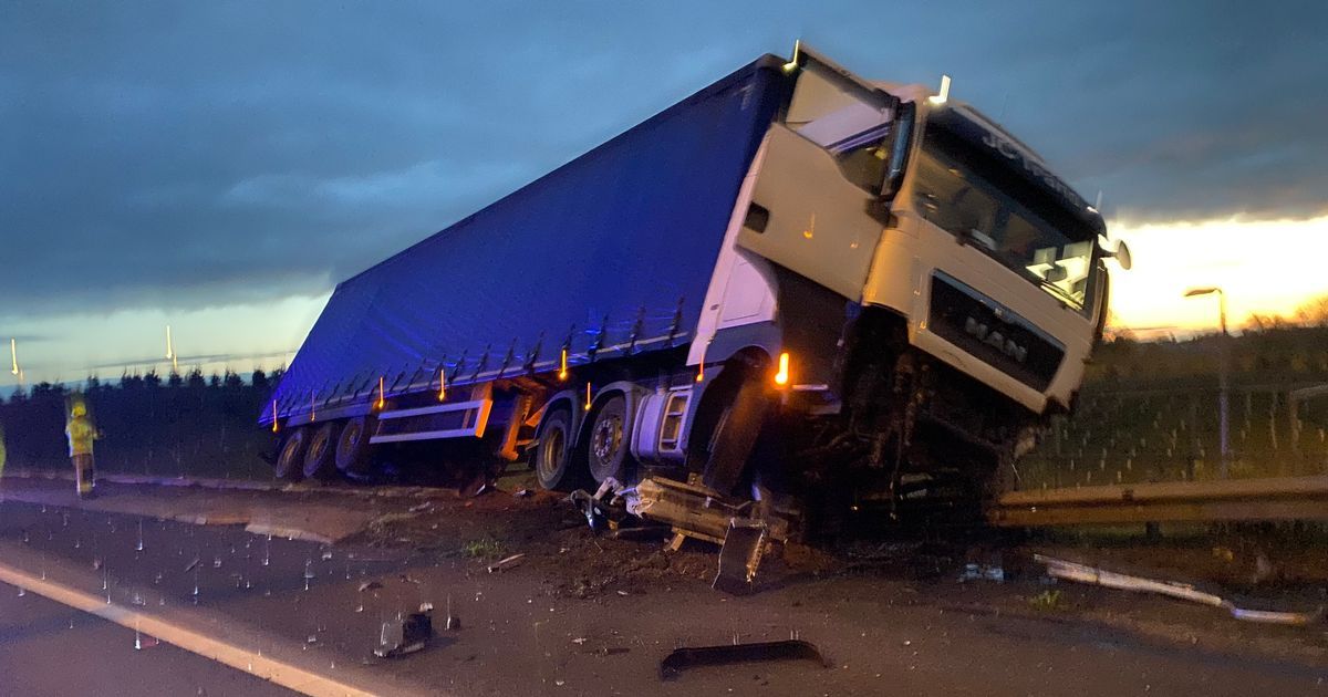 M1 crash as Lorry left hanging off bridge as driver…