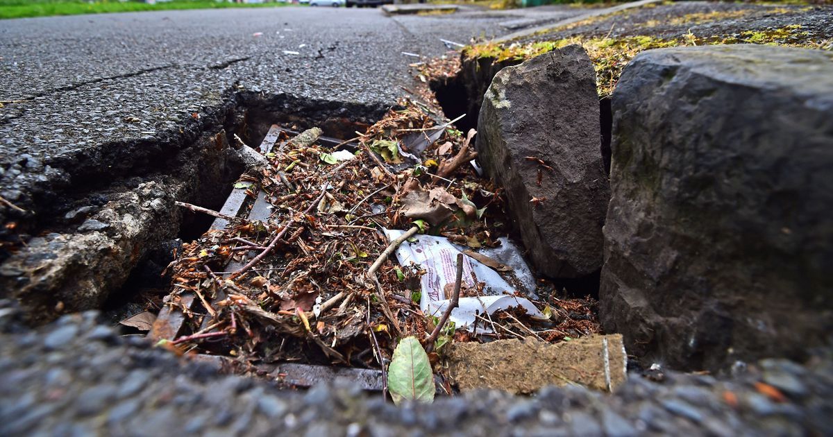 Road taped off as collapsed drain leads to hole in road