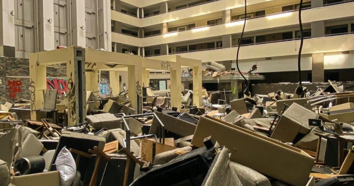 Inside 'apocalyptic' abandoned hotel with rotting pool…