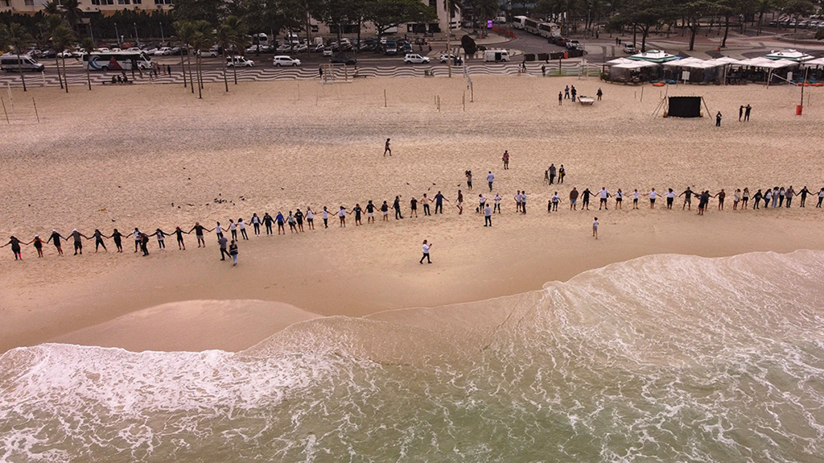 Watch: Brazilians gather to hug Rio de Janeiro beach…