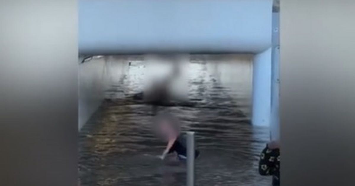 Moment kids SWIM in flooded underpass as water bursts…