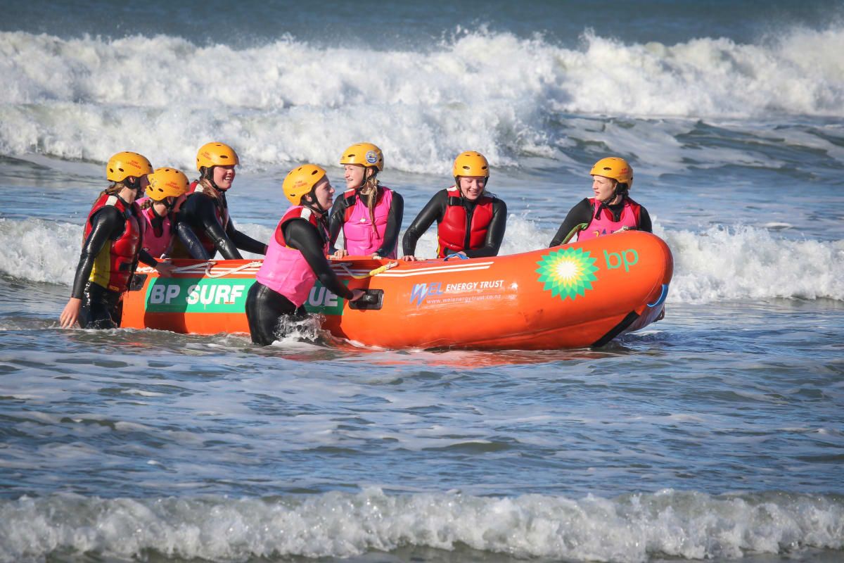 Wāhine on Water riding the wave