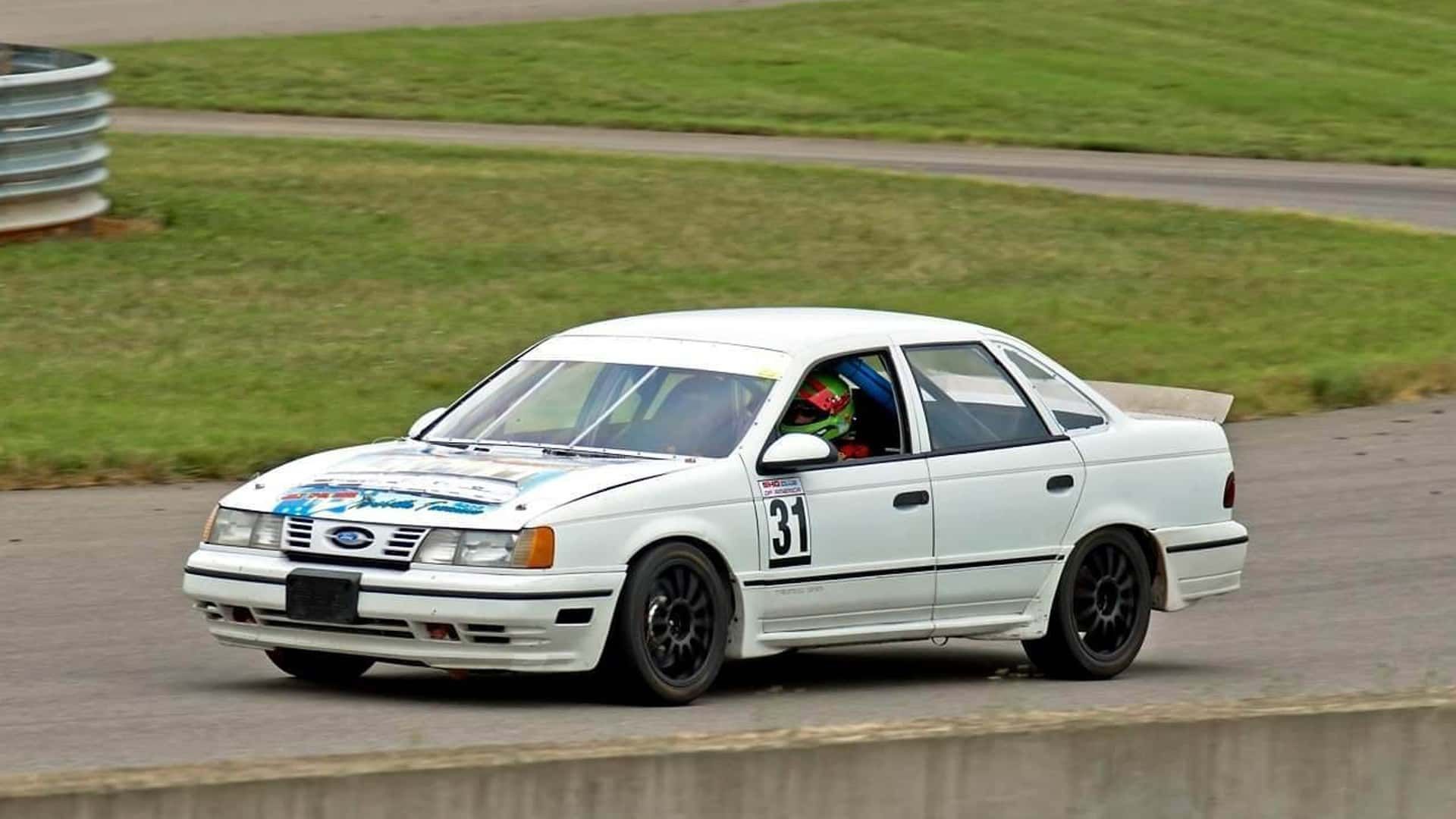 Watch Old Ford Taurus Pass Porsche, BMW, Pace McLaren…