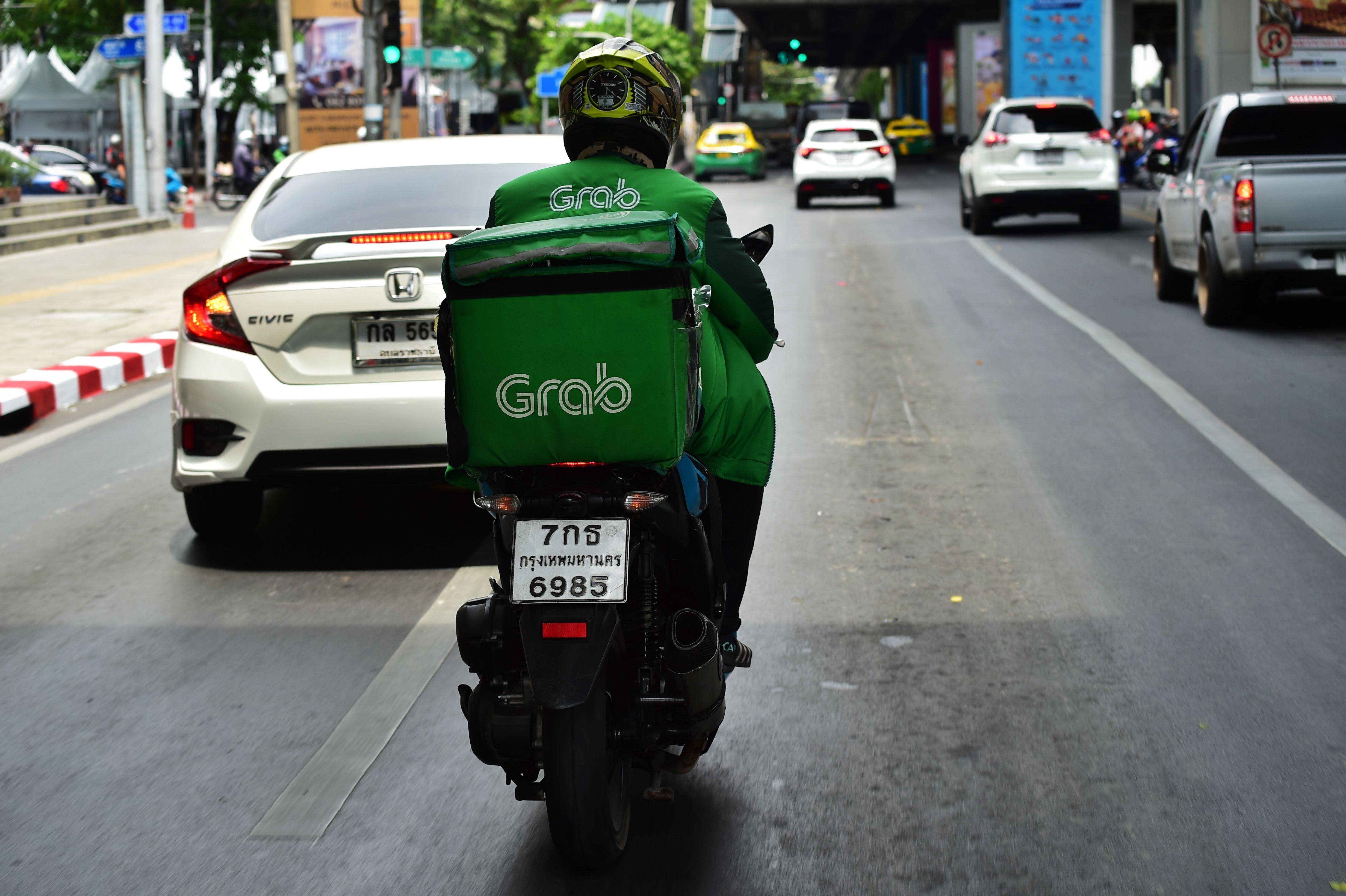 Thailand’s food delivery drivers feel pinch as Grab,…