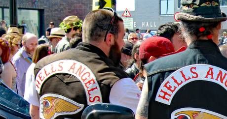 Hells Angels bikie sits stony-faced while being…