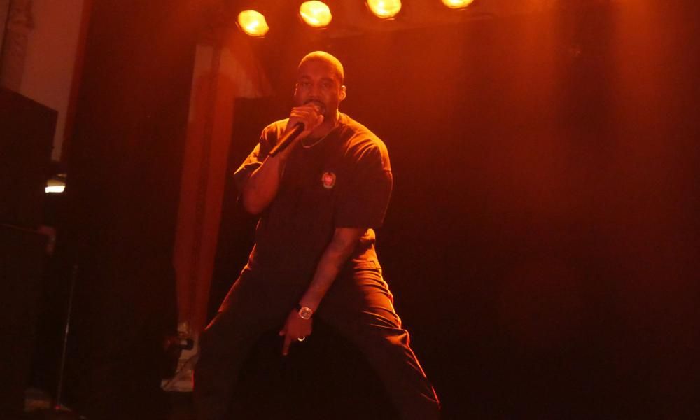 Kanye West fan tries to climb floating stage at…