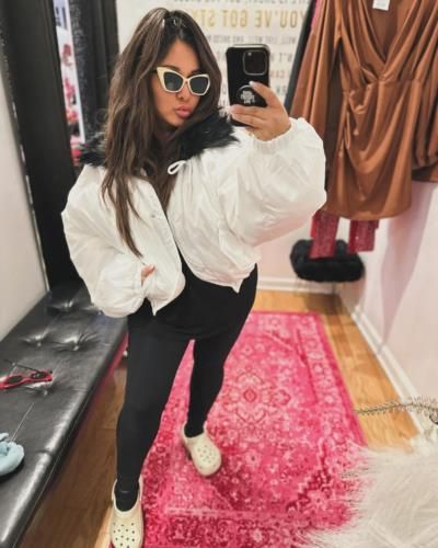 Snooki rocks a chic white coat and killer shades