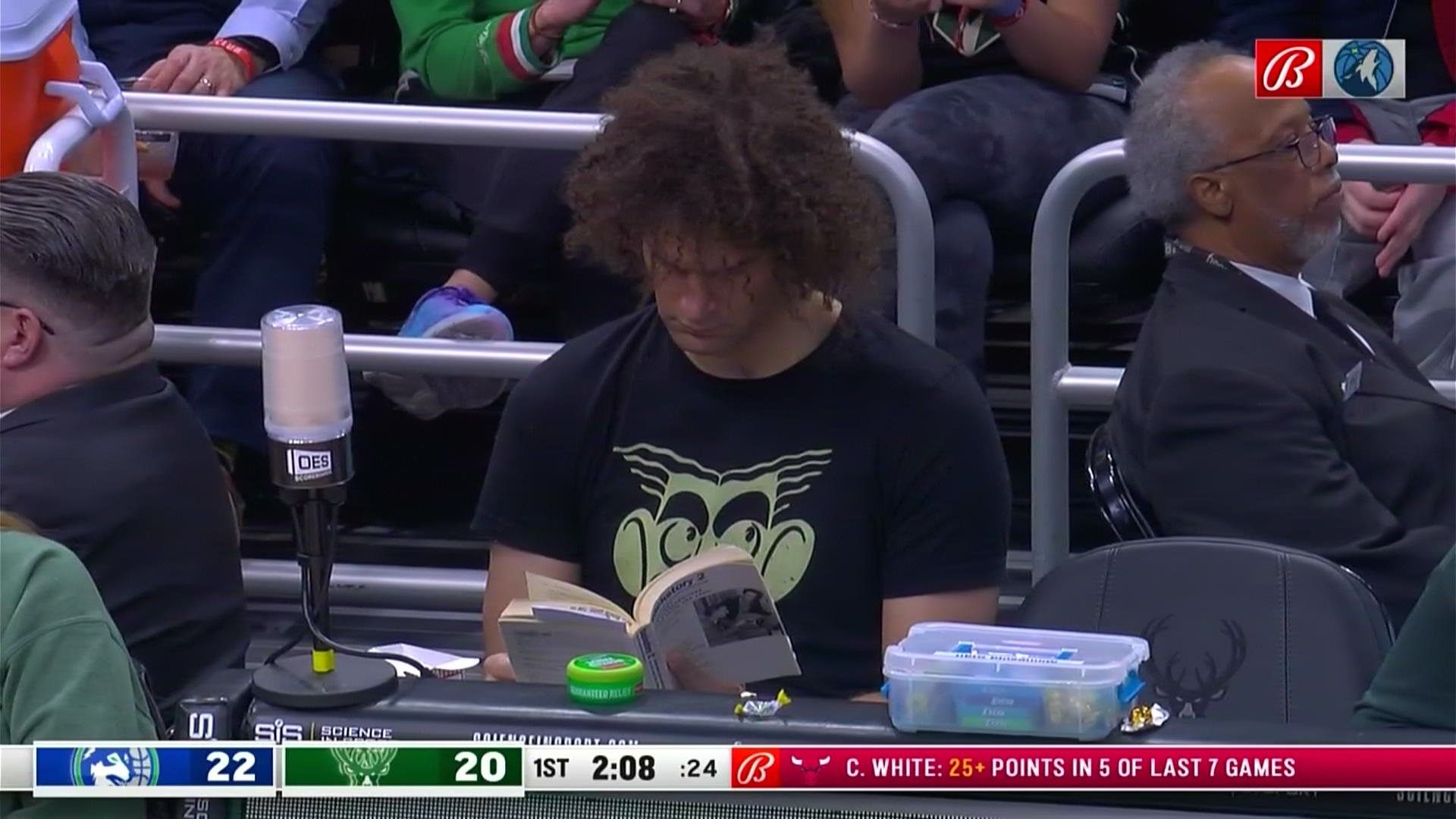 An unemployed Robin Lopez sat courtside and read a…