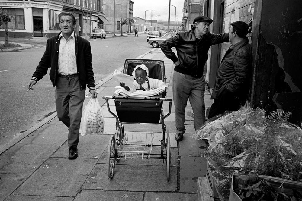 A baby checks her mail between the Toxteth riots: Mike…