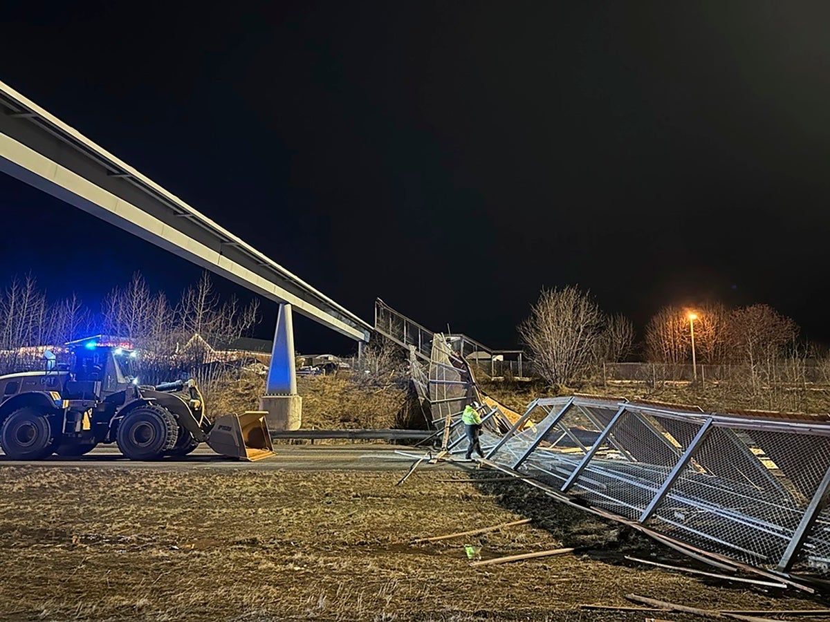 Strong winds knock down pedestrian bridge and close…