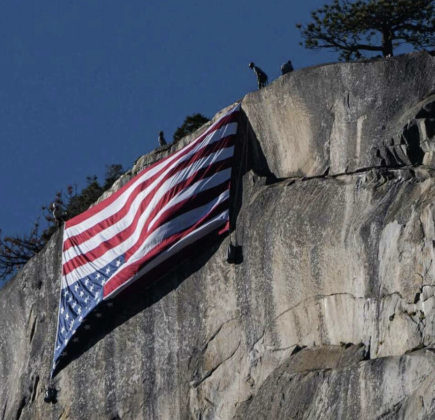 Protestors Display Upside-Down American Flag in…