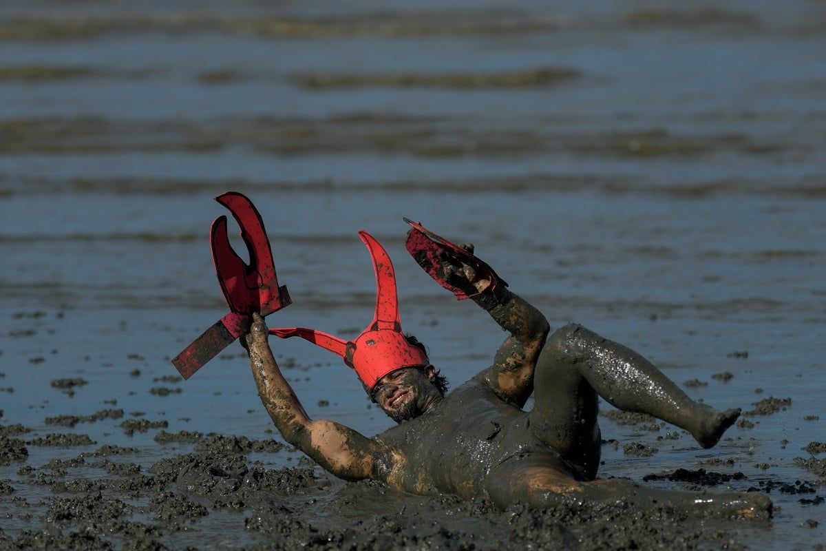 Mud-covered Carnival revelers are a strange sight in…