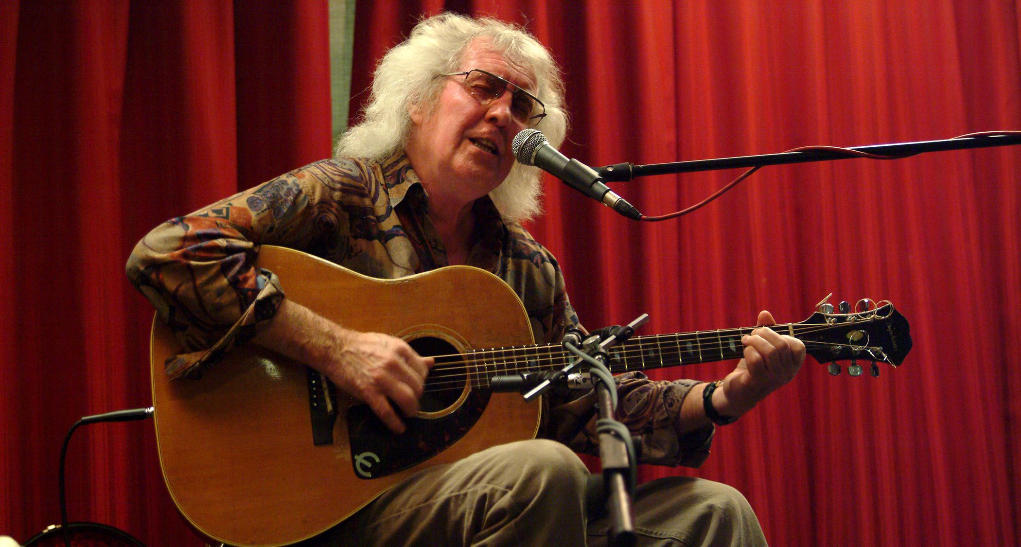 He played a guitar held together by a belt, was…