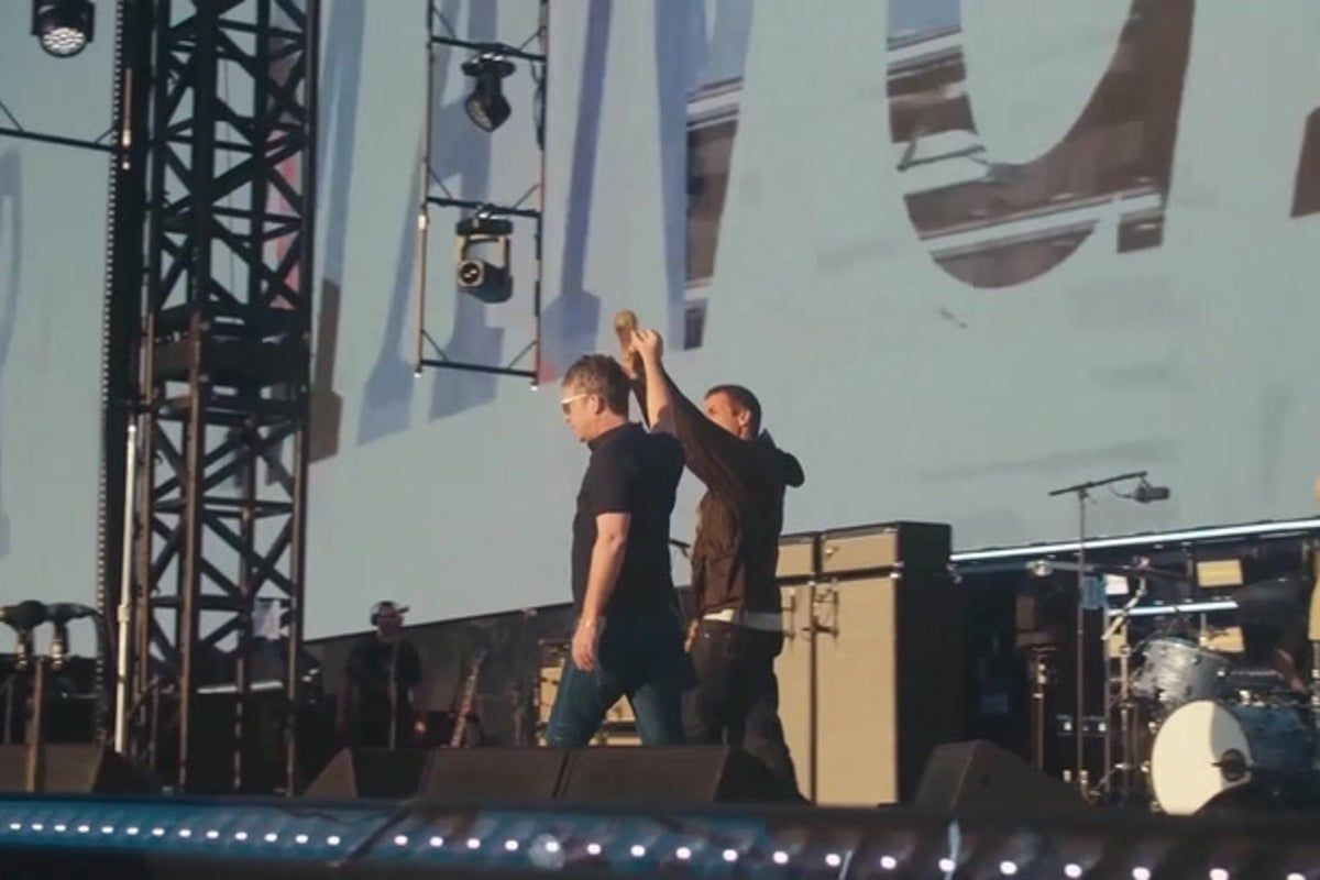 Oasis brothers Liam and Noel Gallagher walk…