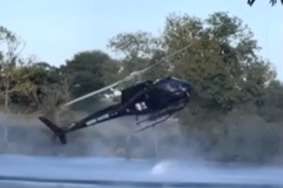 Helicopter crashes into lake while collecting water to…