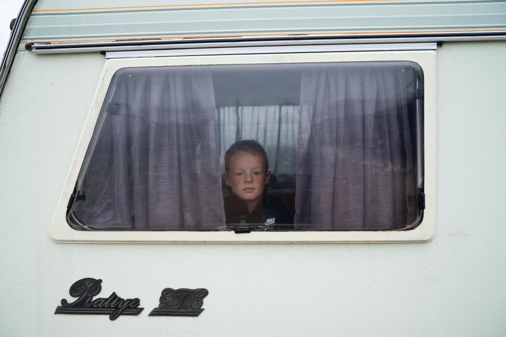 A boy contemplates life from a caravan window: Nik…
