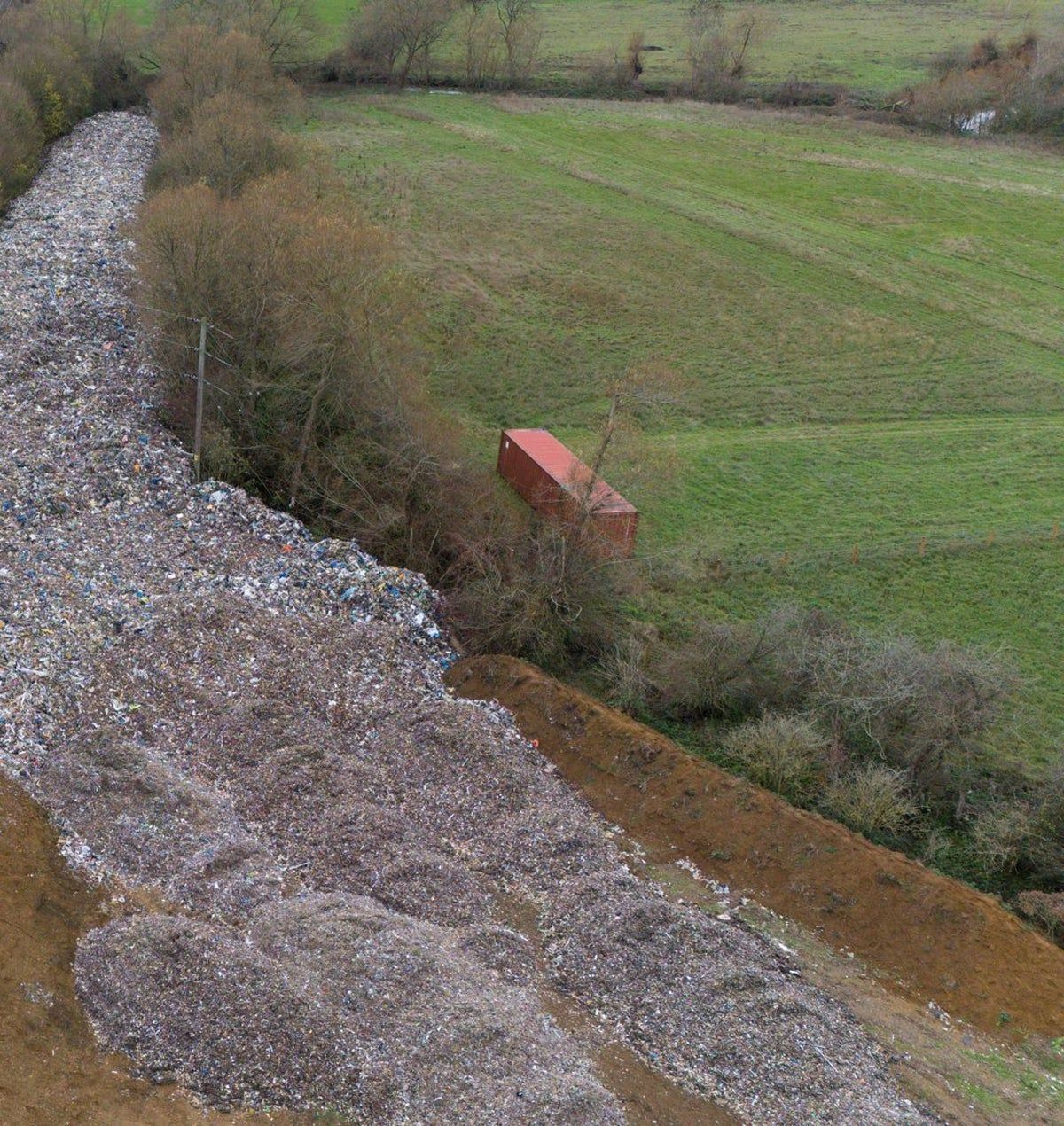 Man arrested after waste illegally dumped near river
