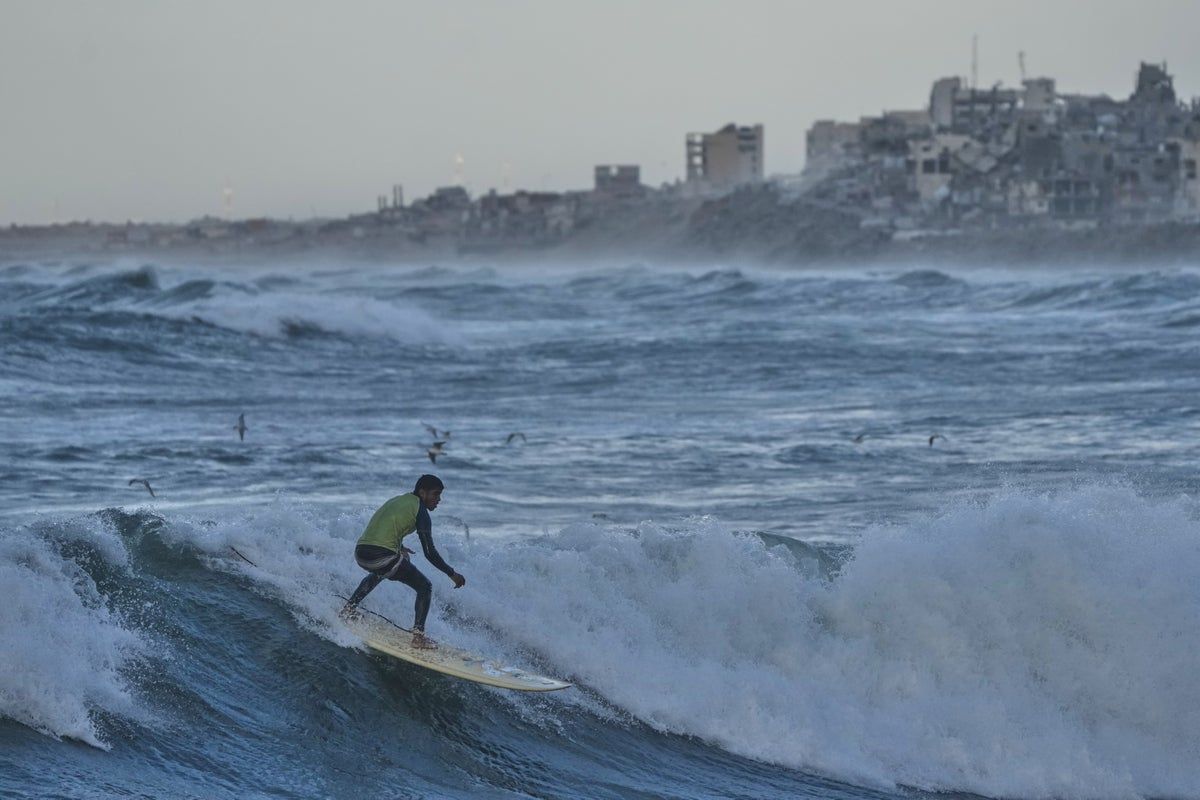 Photos show surfers riding waves along Gaza City’s…