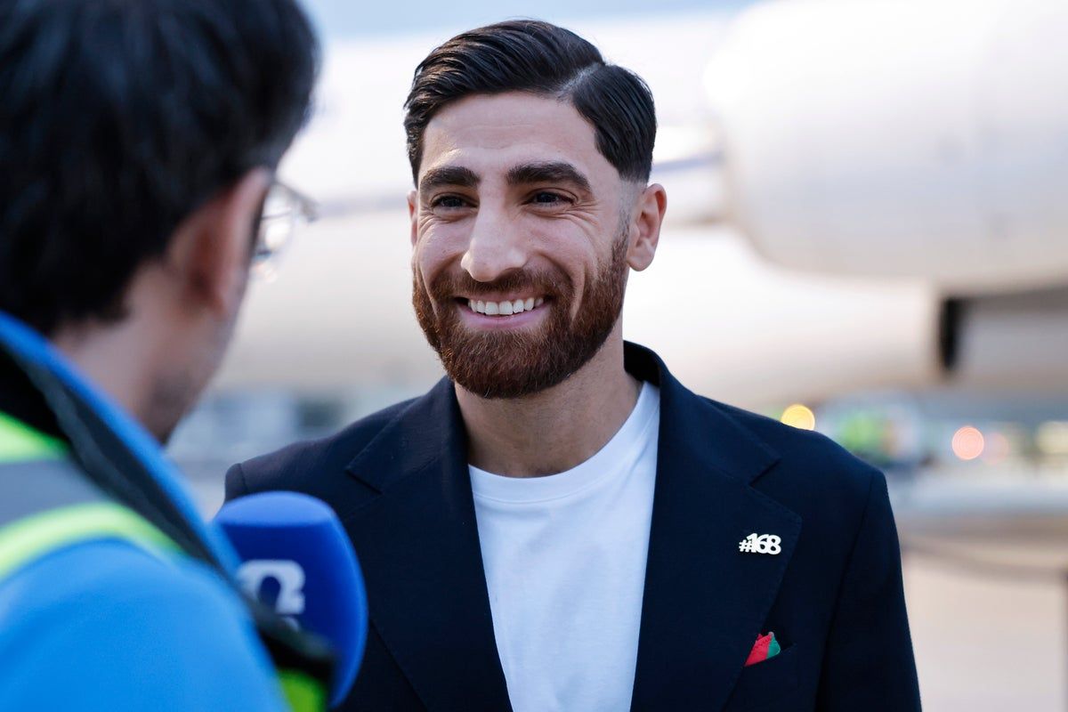Iran’s World Cup players wear #168 lapel pins as they…
