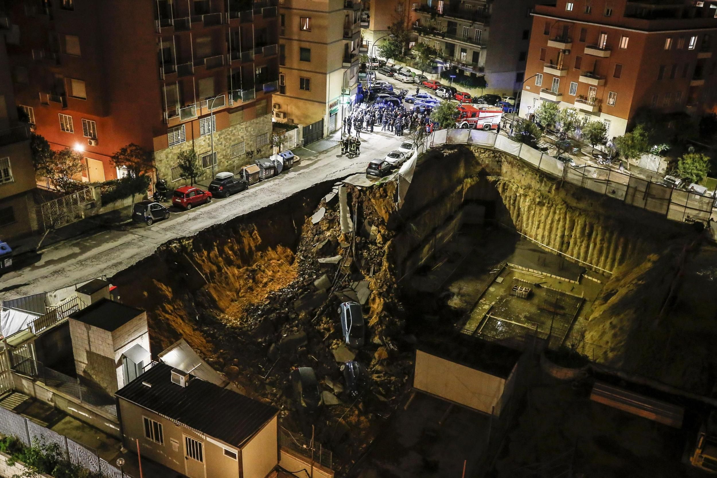 Huge sinkhole swallows cars and forces families to…