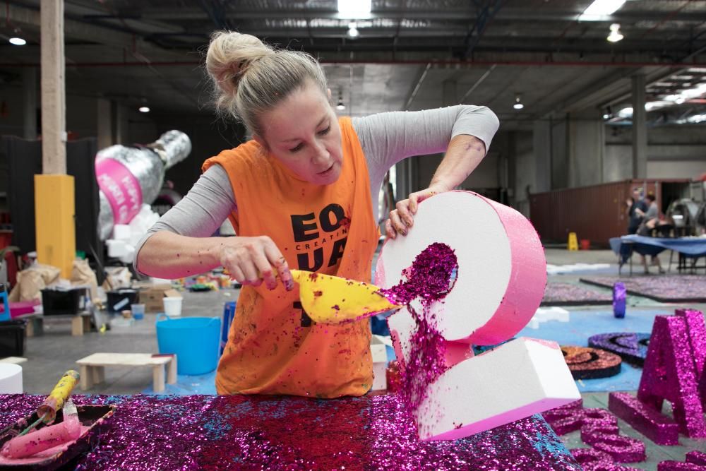 Mardi Gras parade preparations propelled by props and…