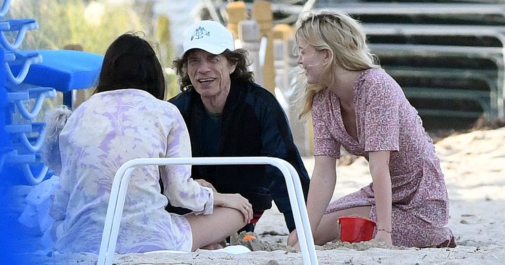 Mick Jagger manages a smile as he's seen for first…