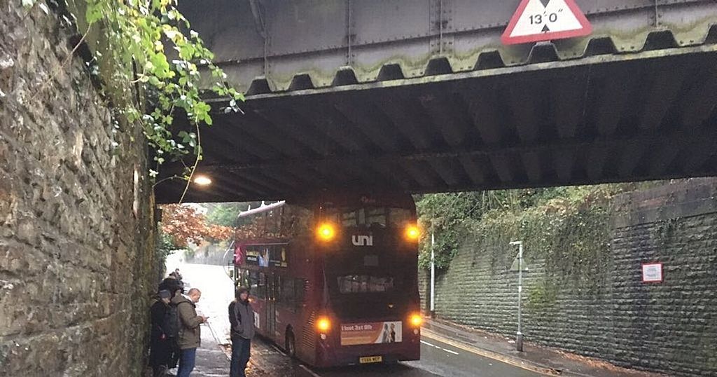 Rail replacement bus gets stuck under bridge after…