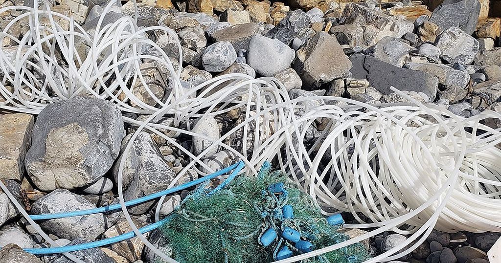 Huge rolls of plastic pipe wash up on beaches across…